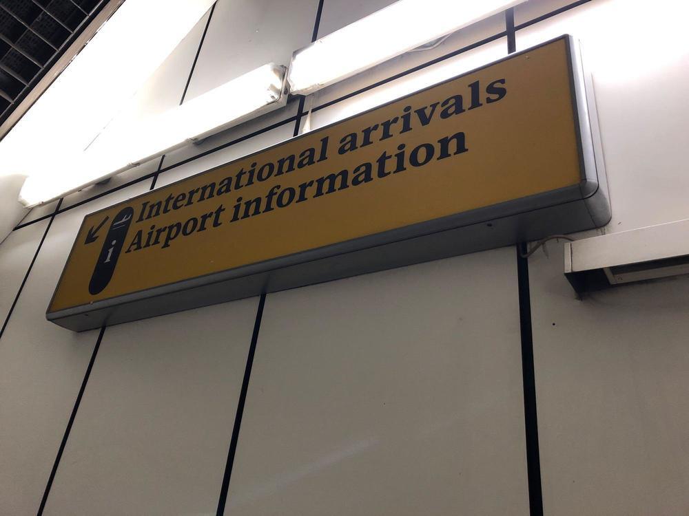 Wall mounted illuminated sign, showing International Arrivals & Airport ...